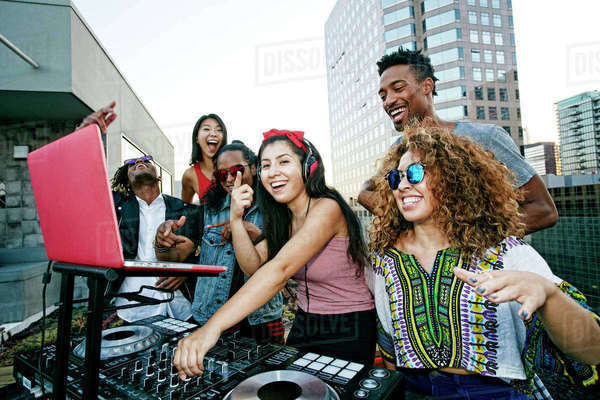 Friends posing with DJ on urban rooftop - Royalty-free Stock Photo ...