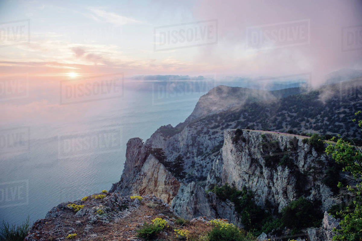 Sunrise from foggy ocean cliff - Royalty-free Stock Photo | Dissolve