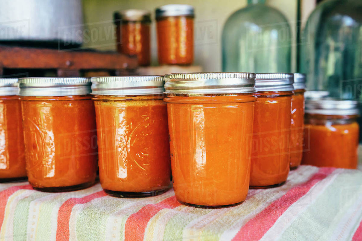 Jars of peach jam on table - Royalty-free Stock Photo | Dissolve