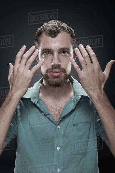 Serious man showing hands - Royalty-free Stock Photo | Dissolve