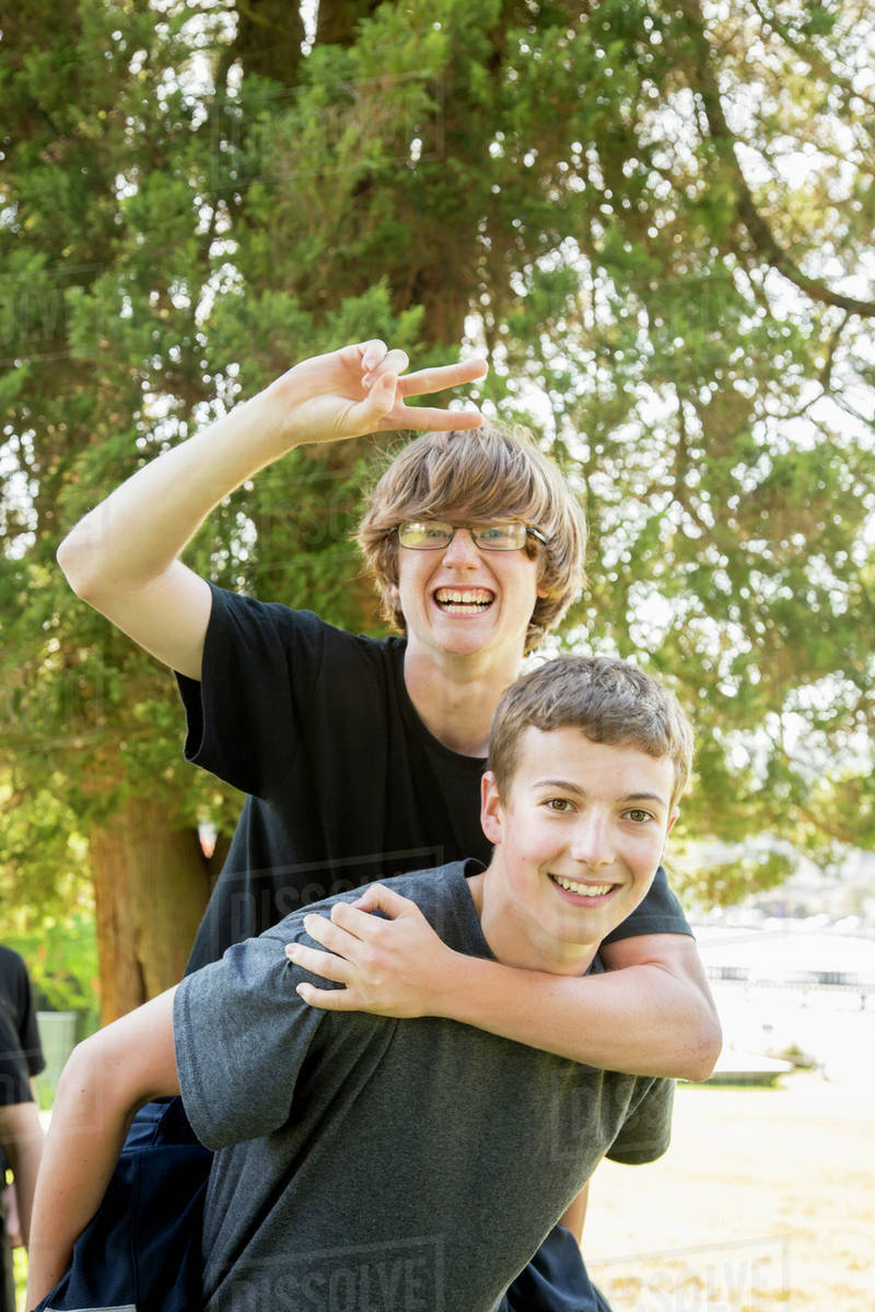 Caucasian teenage piggybacking in park - Royalty-free Stock Photo ...