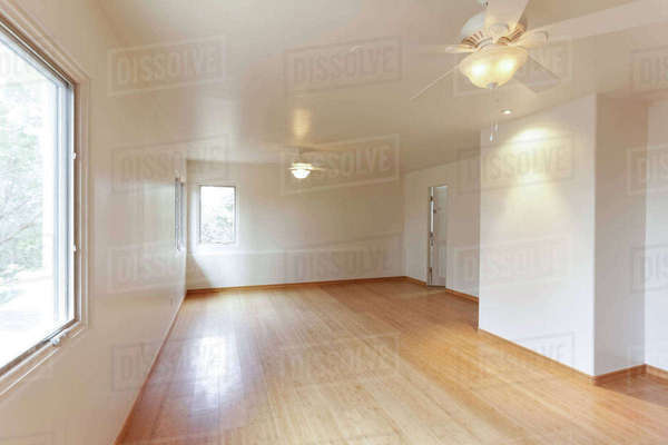 Hardwood floor in empty white room - Royalty-free Stock Photo | Dissolve