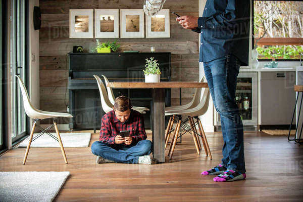 Father and son texting on cell phones - Royalty-free Stock Photo | Dissolve