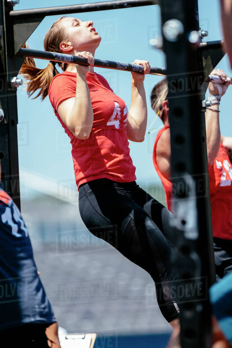 Woman doing chin-ups - Royalty-free Stock Photo | Dissolve