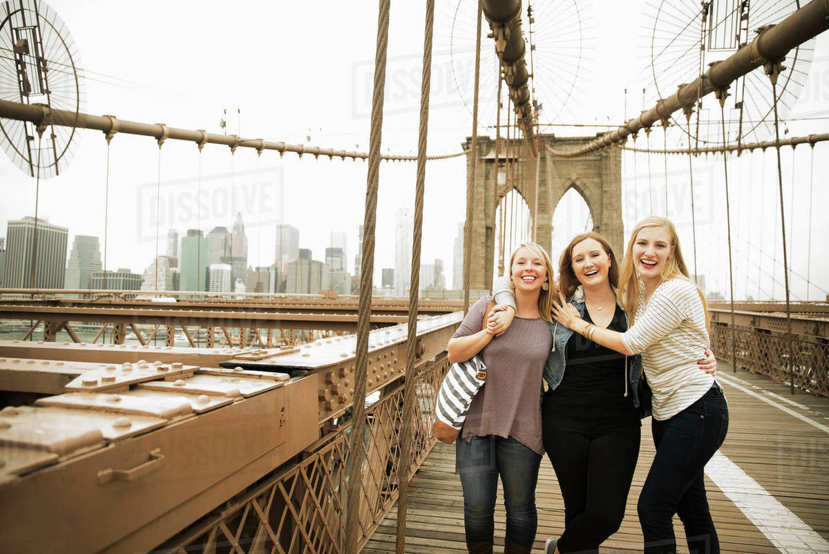 Portrait of smiling women posing on bridge - Royalty-free Stock Photo ...