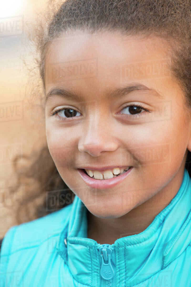Close up of smiling Mixed Race girl - Royalty-free Stock Photo | Dissolve