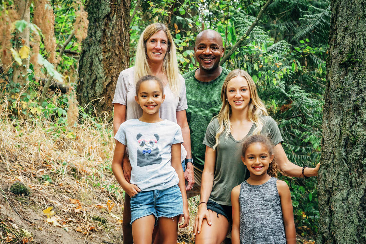 Multi-ethnic family posing in forest - Royalty-free Stock Photo | Dissolve