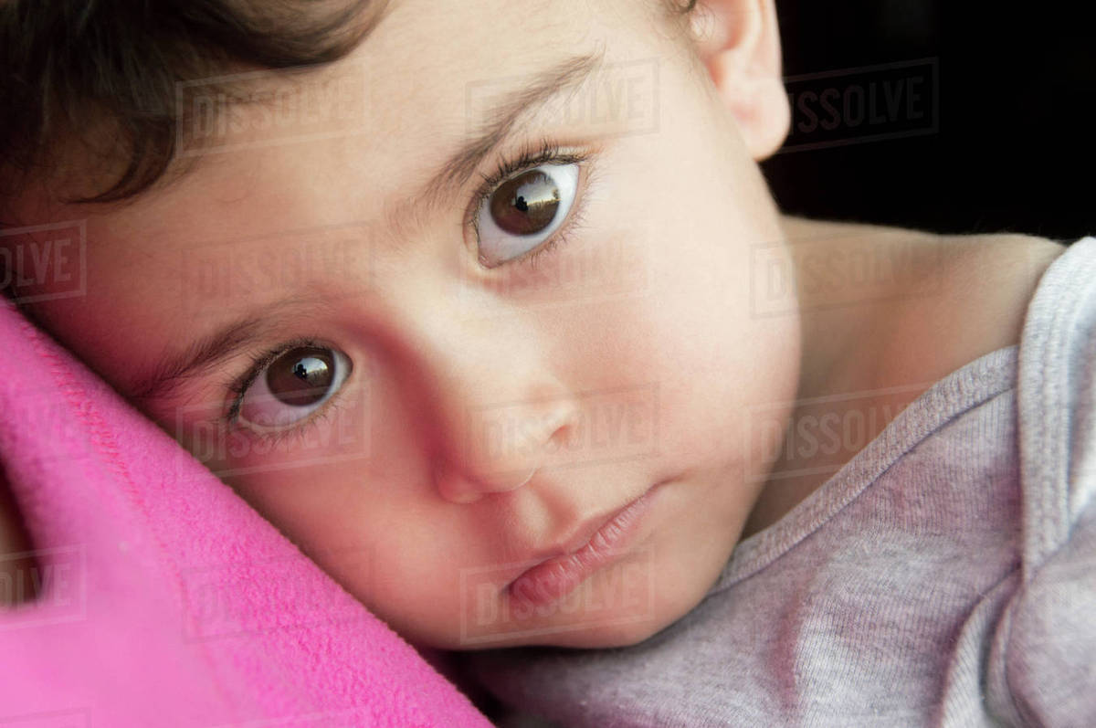 Serious Hispanic boy resting head on chest of mother - Stock Photo ...