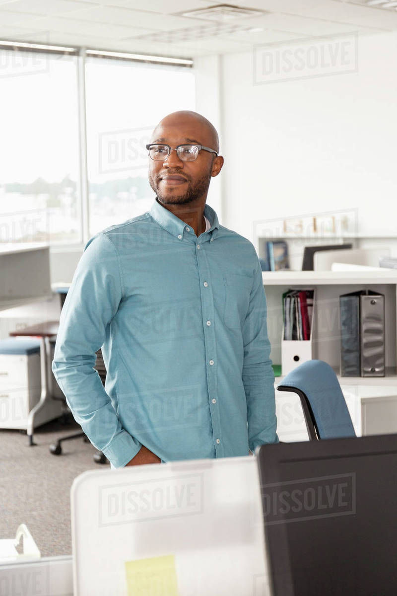 Smiling African American man standing in office - Royalty-free Stock ...