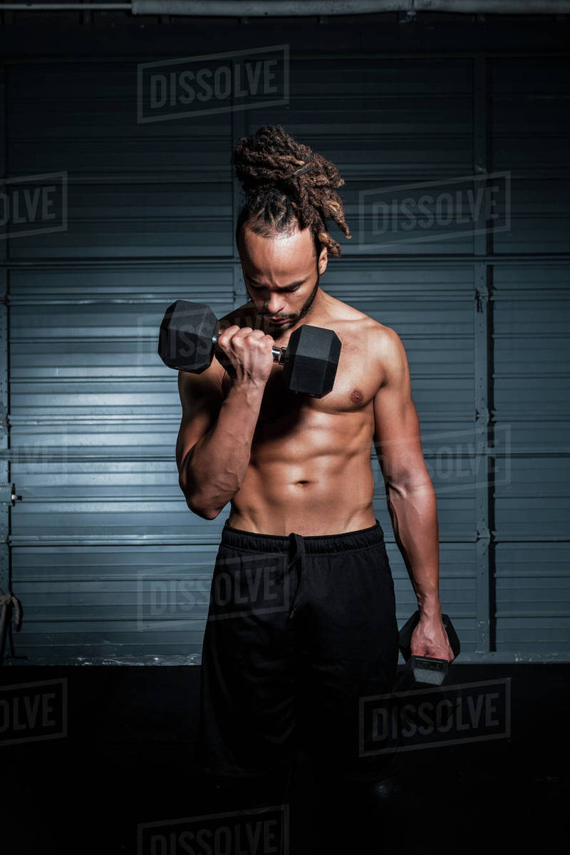 Mixed Race man lifting weights in gymnasium - Royalty-free Stock Photo ...