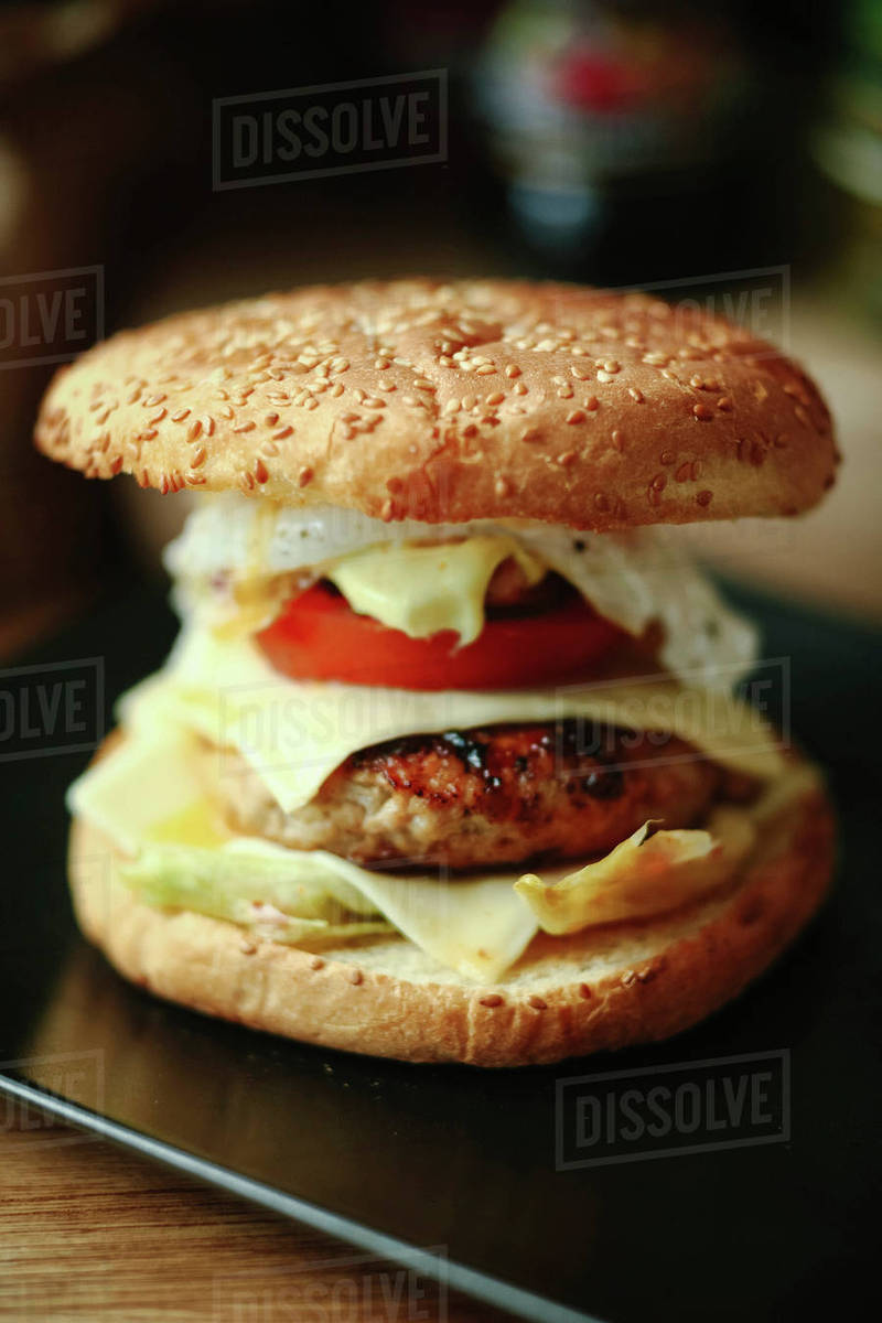 Gourmet cheeseburger on plate - Stock Photo - Dissolve