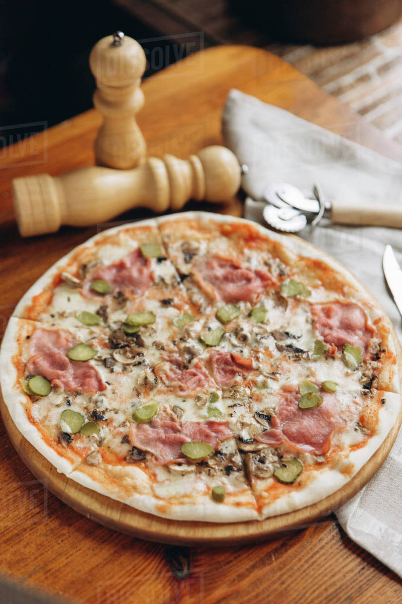 Pizza pie on table - Royalty-free Stock Photo | Dissolve