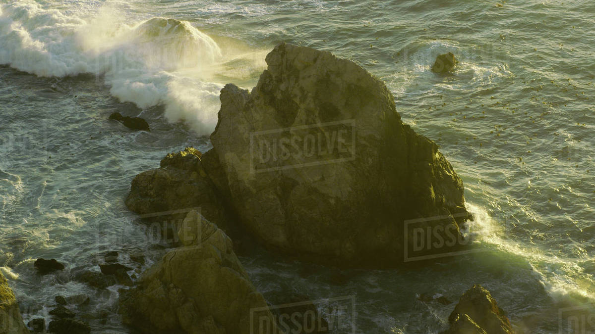 Ocean waves splashing on rocks - Stock Photo - Dissolve