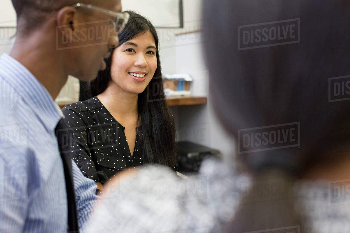 Smiling people talking in meeting - Royalty-free Stock Photo | Dissolve