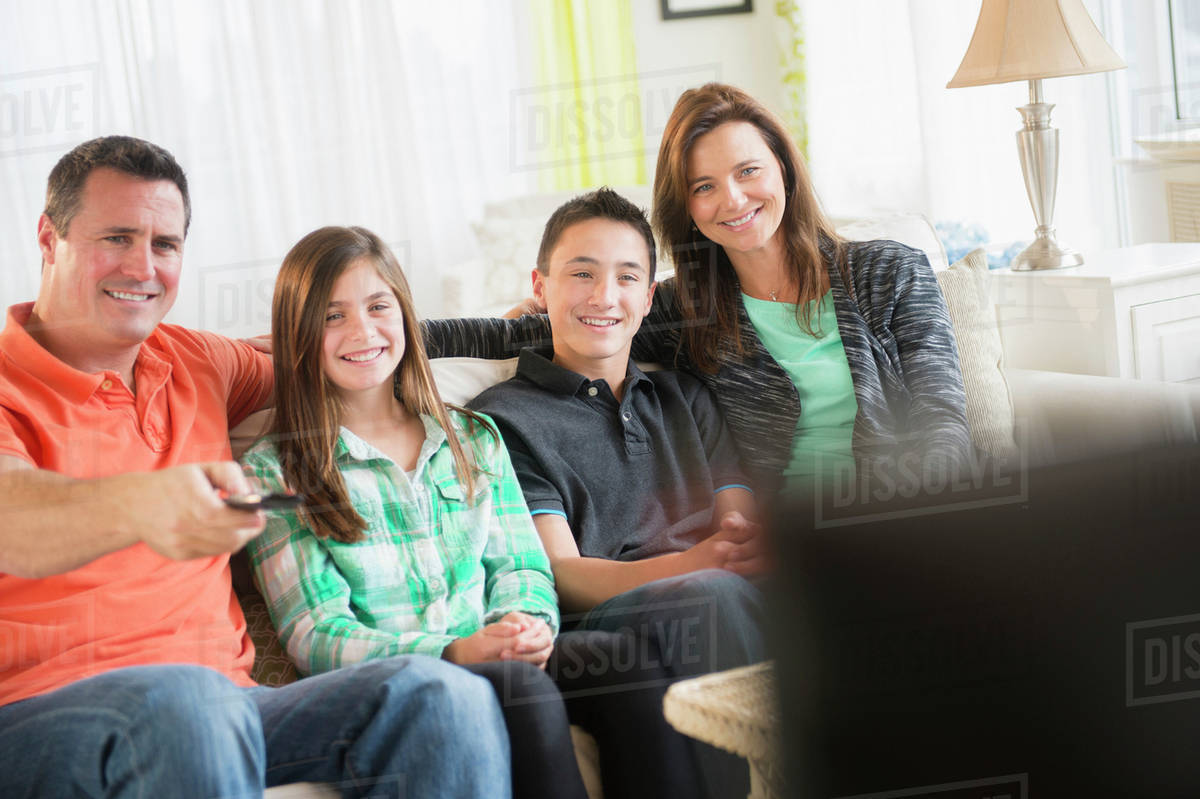 Caucasian family watching TV in living room - Royalty-free Stock Photo ...