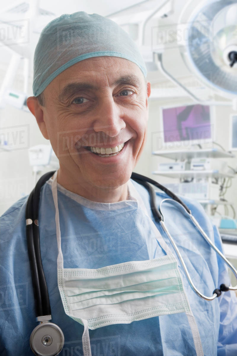 Close up portrait of smiling Hispanic surgeon - Stock Photo - Dissolve