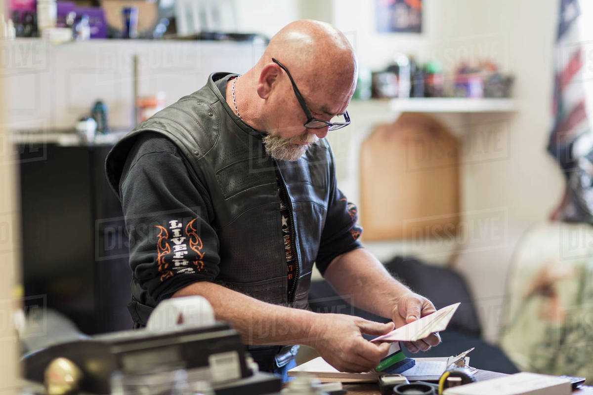 Caucasian man reading paperwork on clipboard - Royalty-free Stock Photo ...