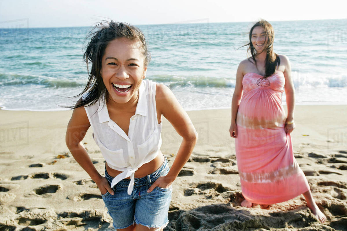Women laughing on beach - Royalty-free Stock Photo | Dissolve