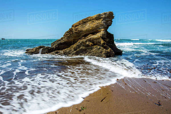Waves splashing on rock at ocean beach - Royalty-free Stock Photo ...