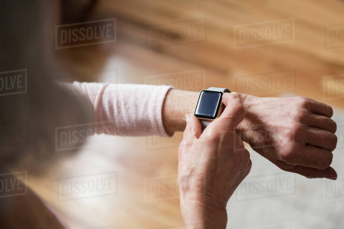 Older woman checking smart watch - Royalty-free Stock Photo | Dissolve