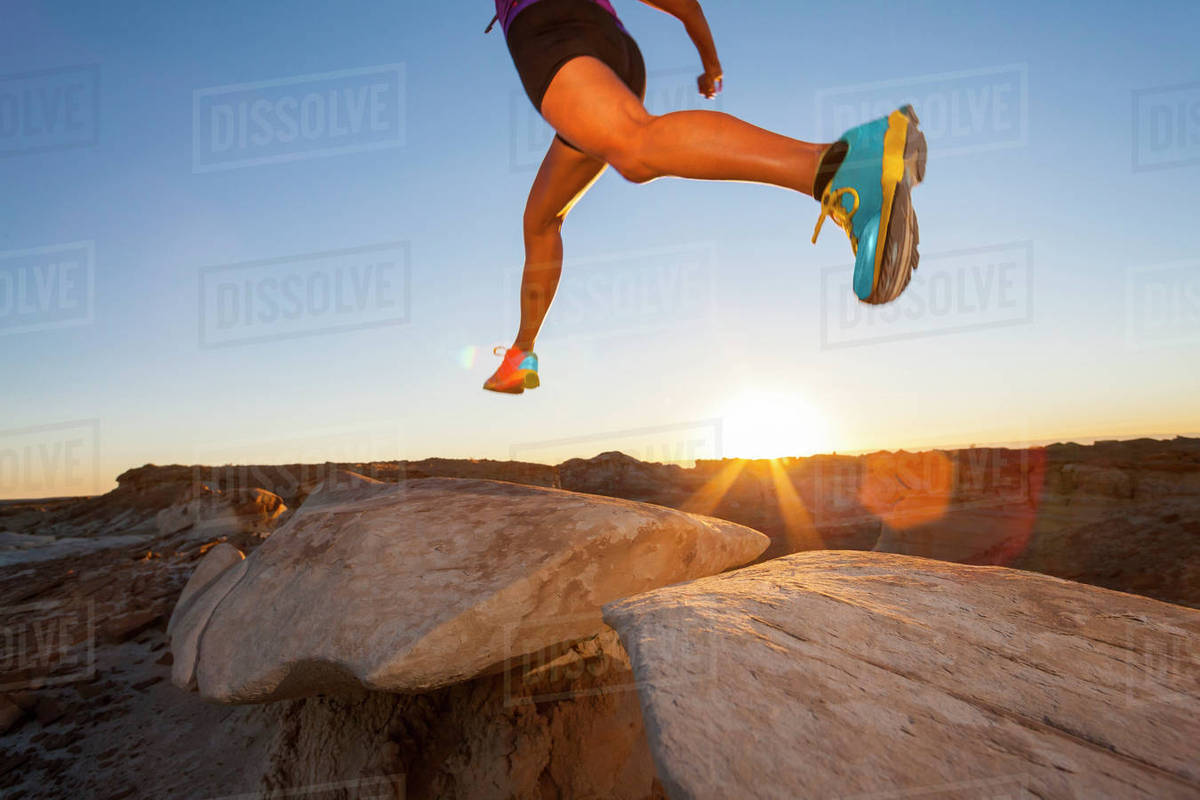Native American woman running and jumping in desert - Royalty-free ...