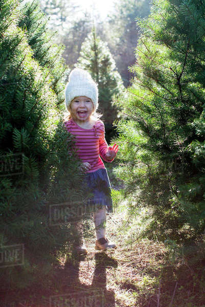Excited Caucasian girl standing near trees - Stock Photo - Dissolve