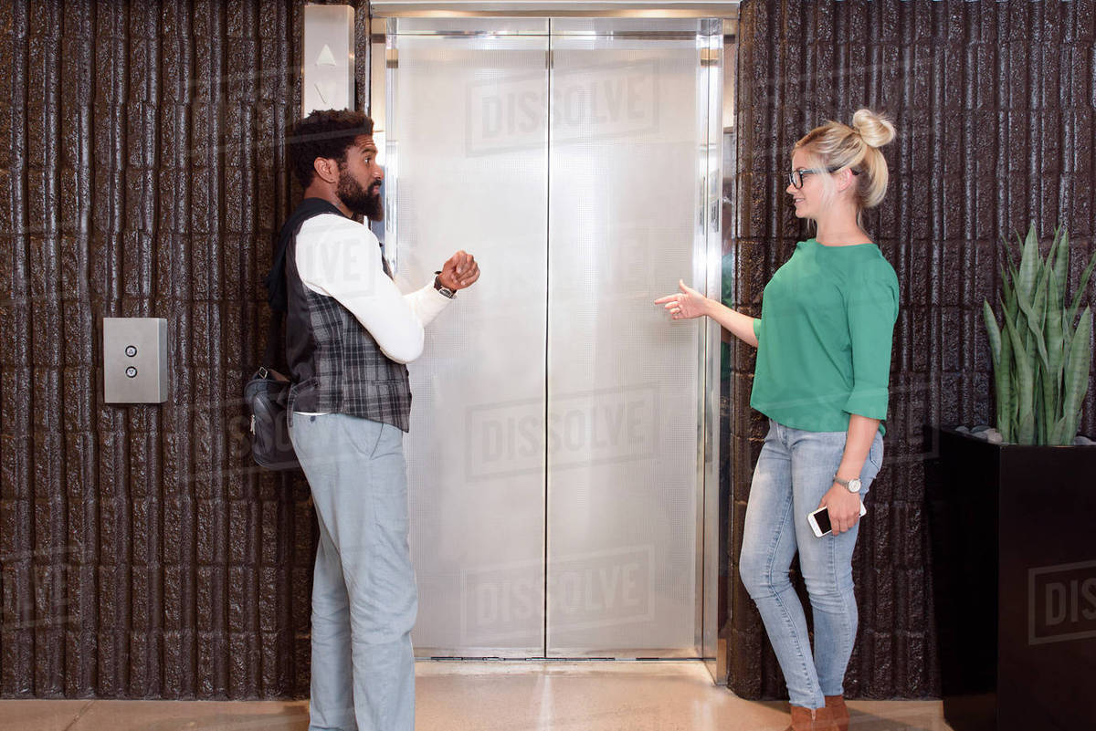 Man and woman waiting for elevator - Stock Photo - Dissolve