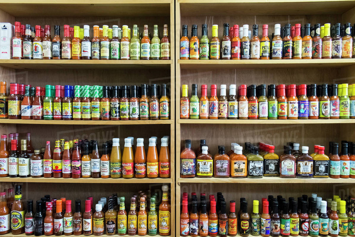Jars of sauce on shelves in store - Stock Photo - Dissolve