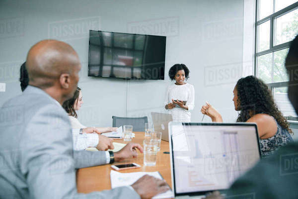 Businesswoman talking near visual screen in meeting - Stock Photo ...