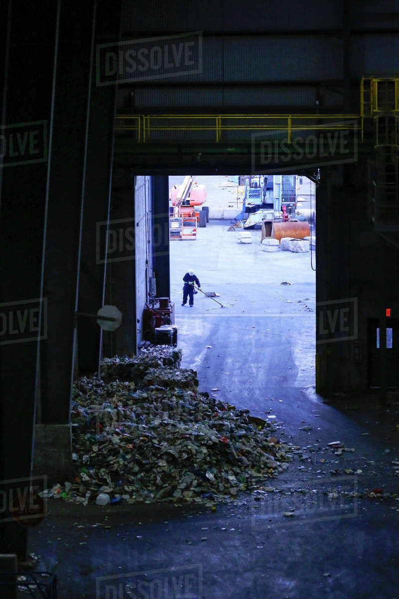 Man sweeping garbage with broom - Royalty-free Stock Photo | Dissolve