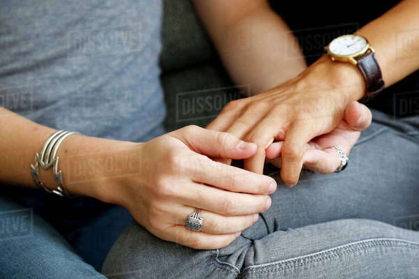 Women holding hands - Stock Photo - Dissolve