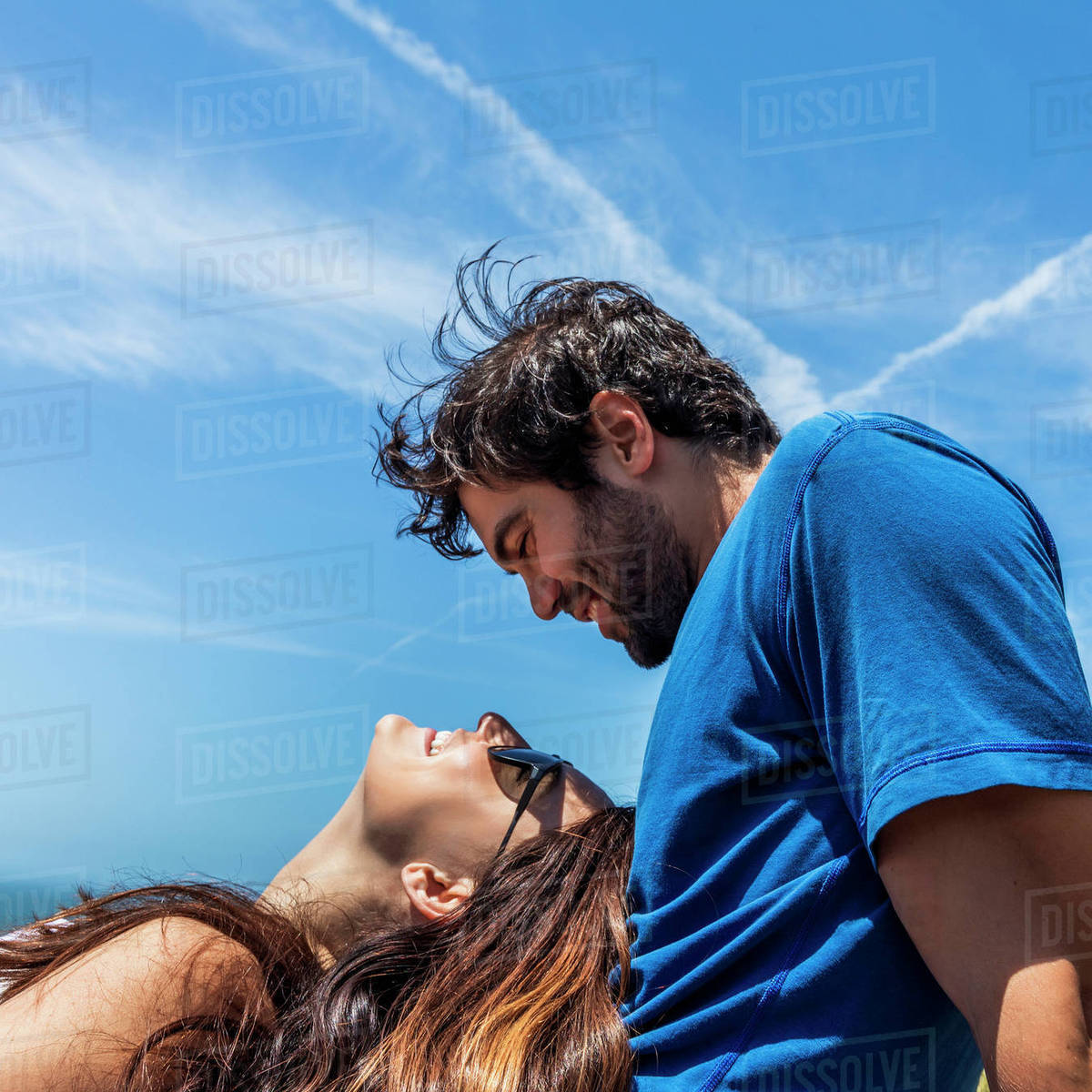 Caucasian woman laying in lap of man - Stock Photo - Dissolve