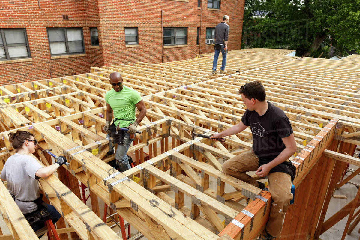 Volunteers hammering at construction site - Royalty-free Stock Photo ...