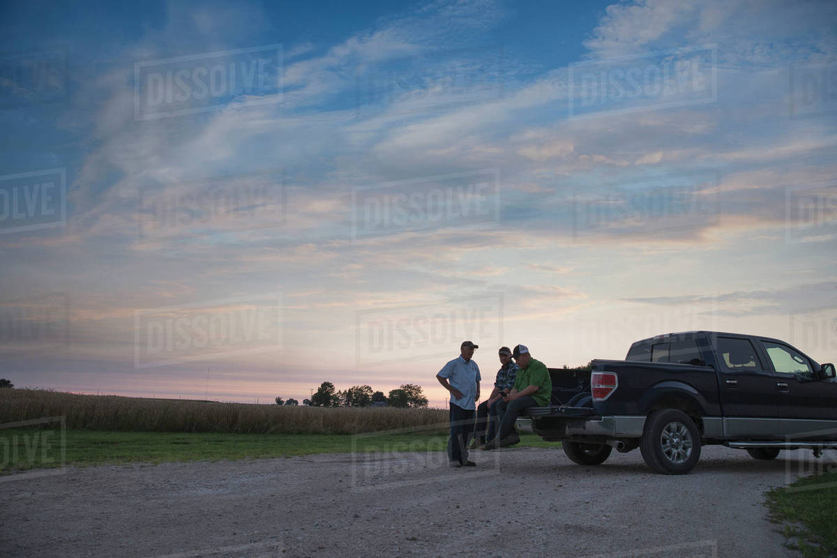 Caucasian men at pick-up truck at sunset - Royalty-free Stock Photo ...