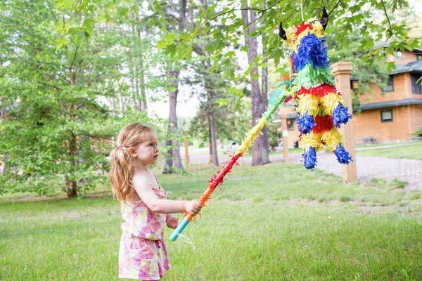 Caucasian girl hitting pinata outdoors - Royalty-free Stock Photo ...