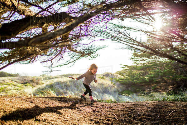 Caucasian girl running under tree branches - Royalty-free Stock Photo ...