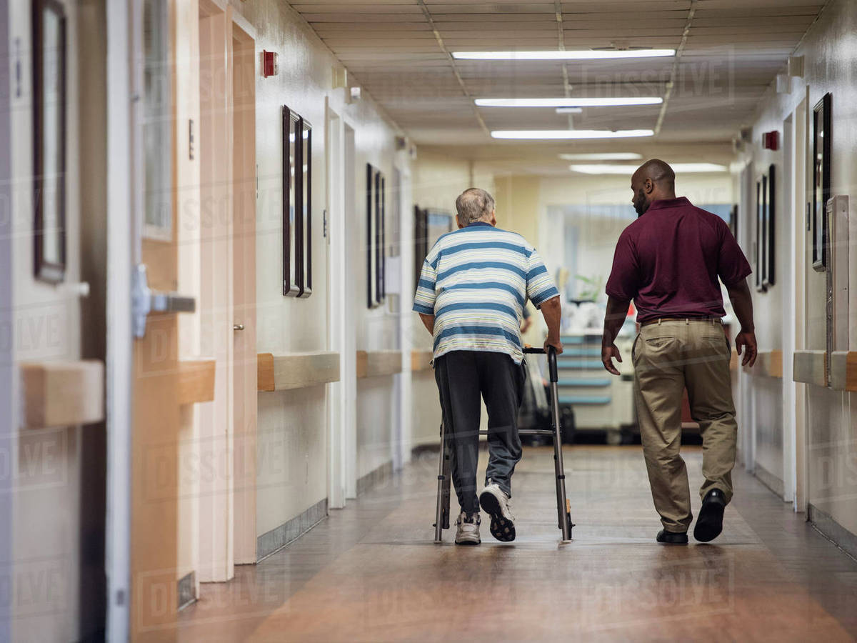 Nurse walking with patient using walker - Royalty-free Stock Photo ...