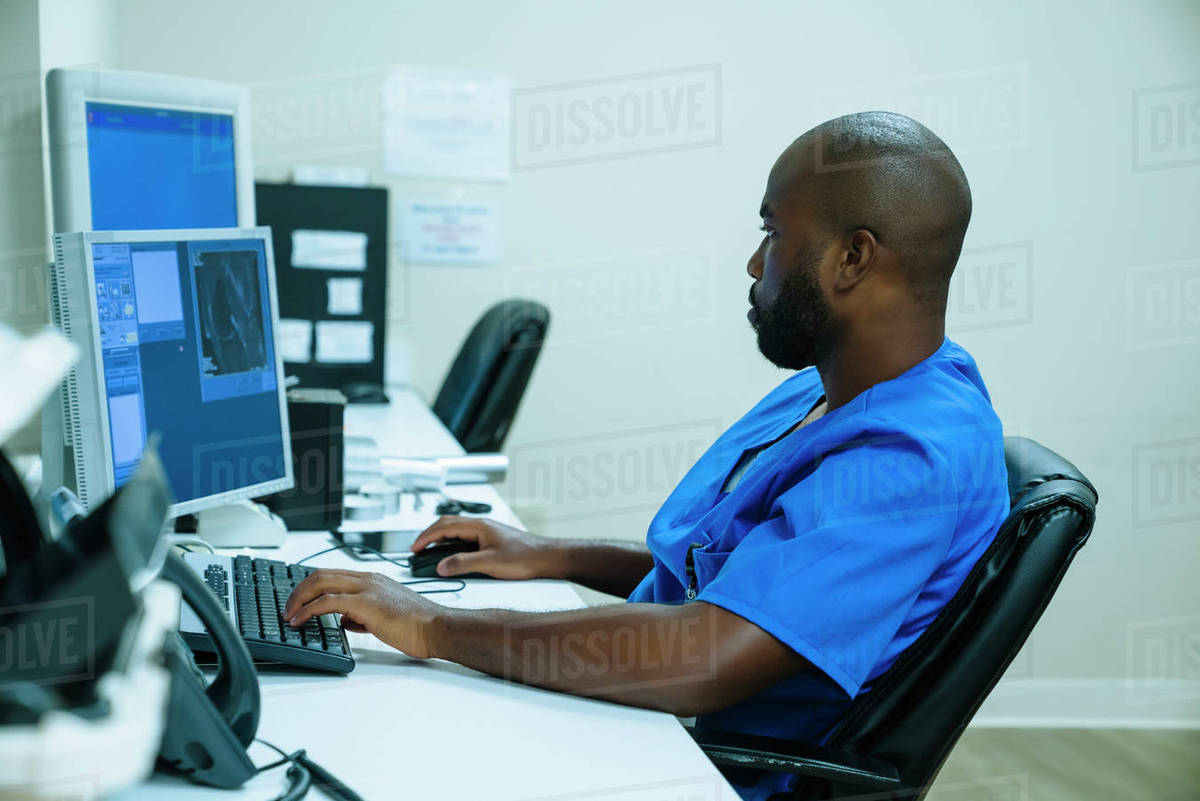 Black nurse using computer - Royalty-free Stock Photo | Dissolve