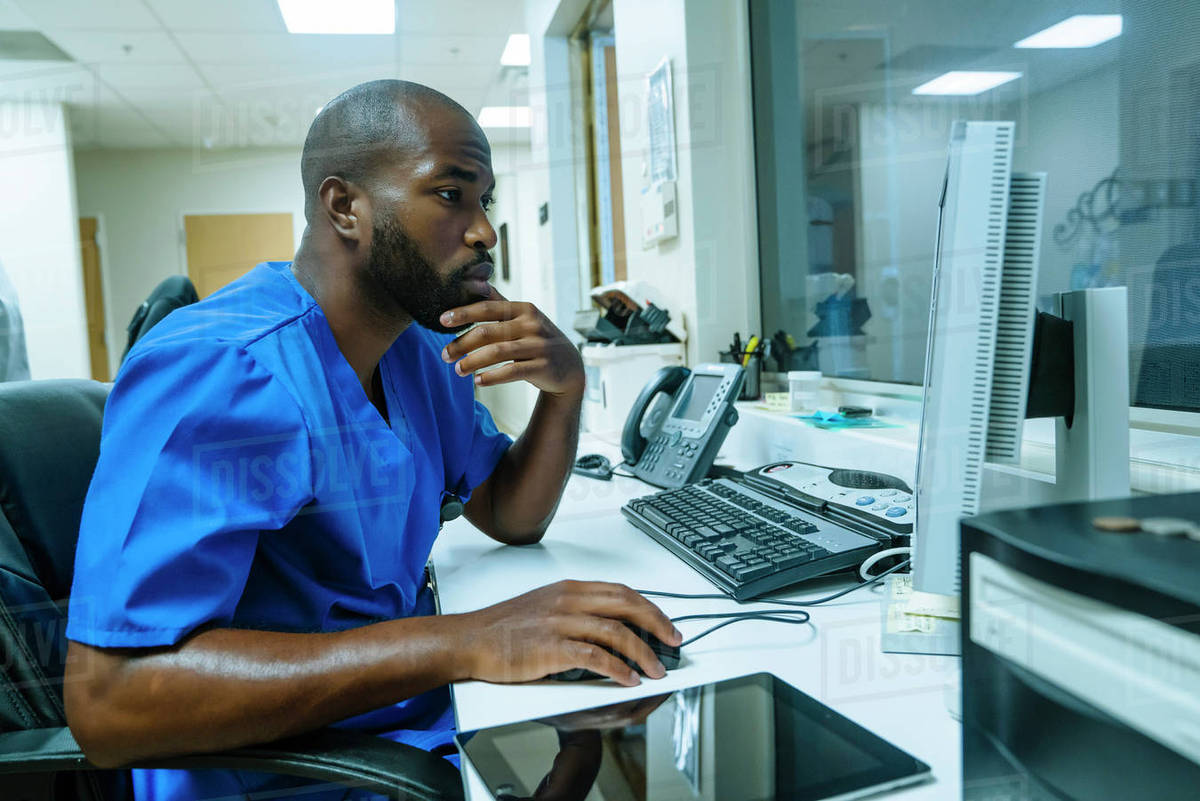 Black nurse using computer - Royalty-free Stock Photo | Dissolve
