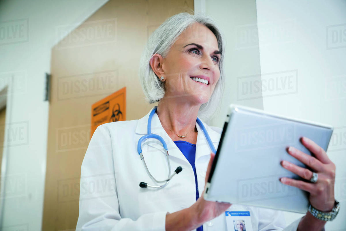 Caucasian doctor using digital tablet - Royalty-free Stock Photo | Dissolve
