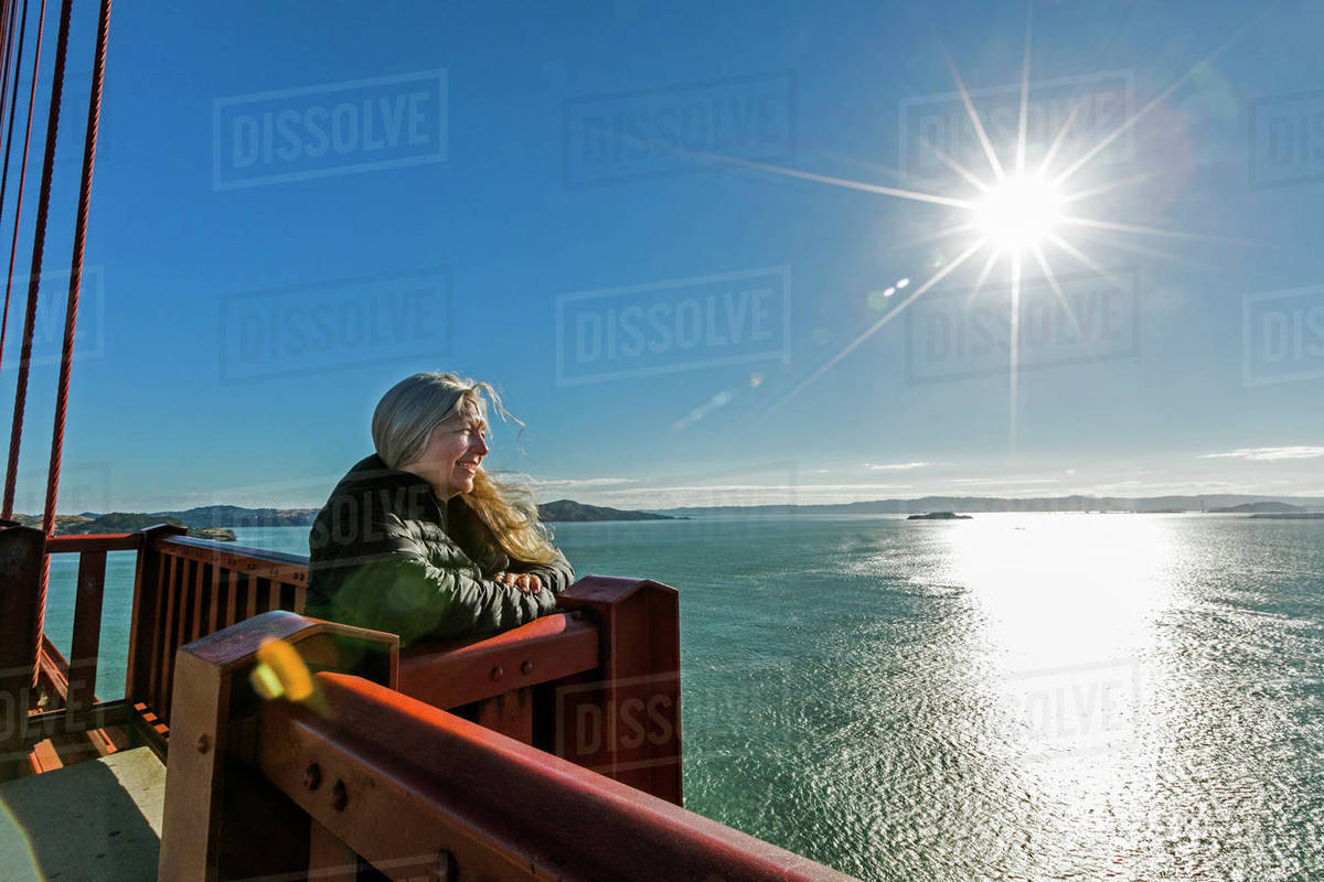 Caucasian woman admiring scenic view on bridge - Royalty-free Stock ...