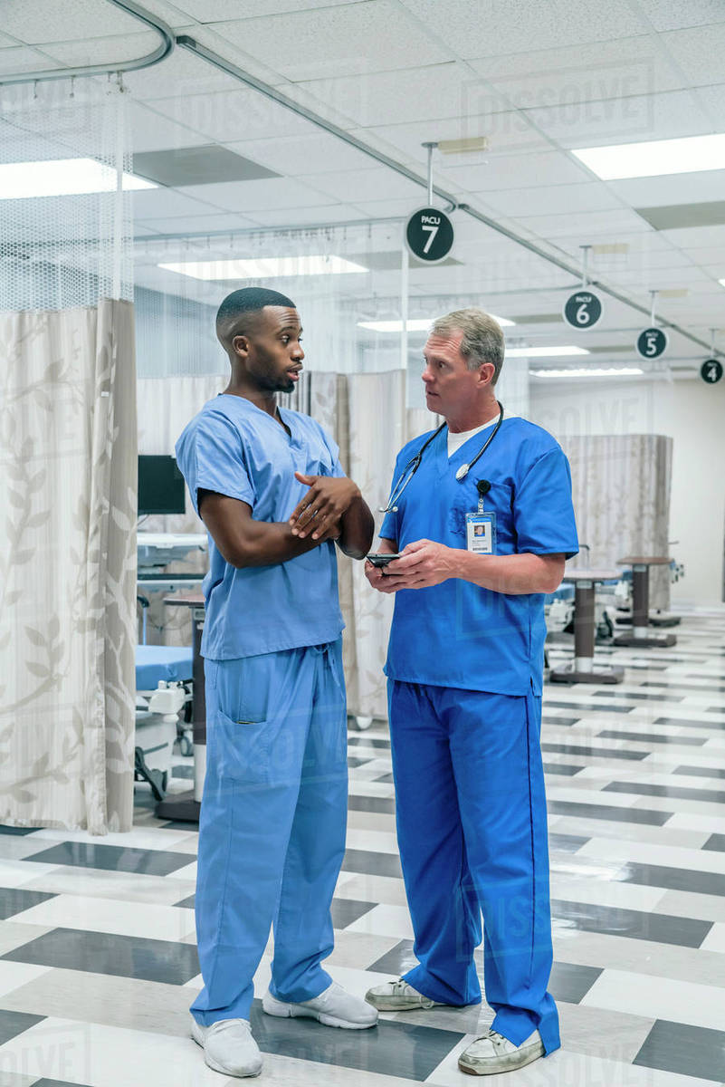 Doctors talking in hospital - Royalty-free Stock Photo | Dissolve