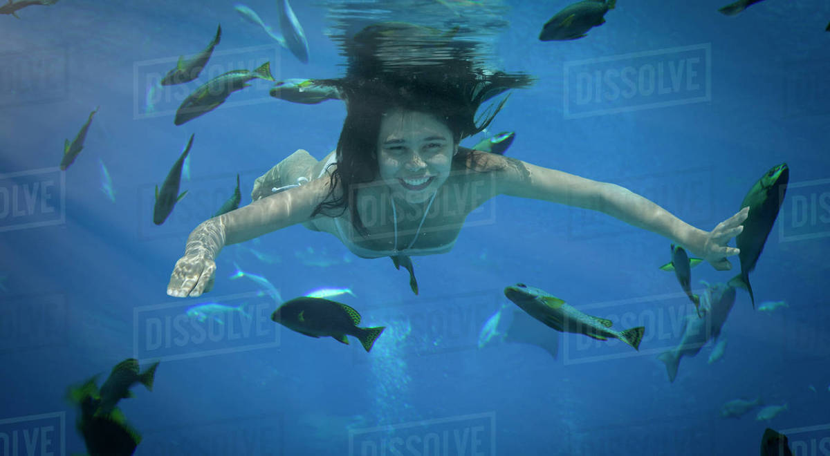 Asian woman swimming underwater with fish - Royalty-free Stock Photo ...