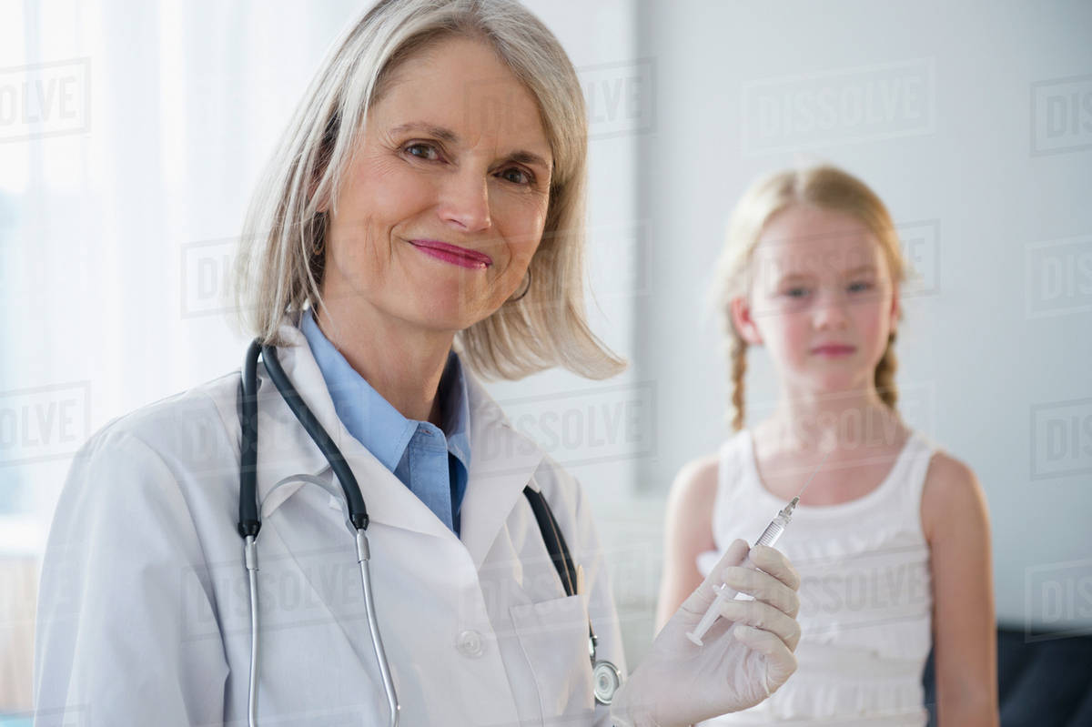 Caucasian doctor taking patient's temperature - Stock Photo - Dissolve