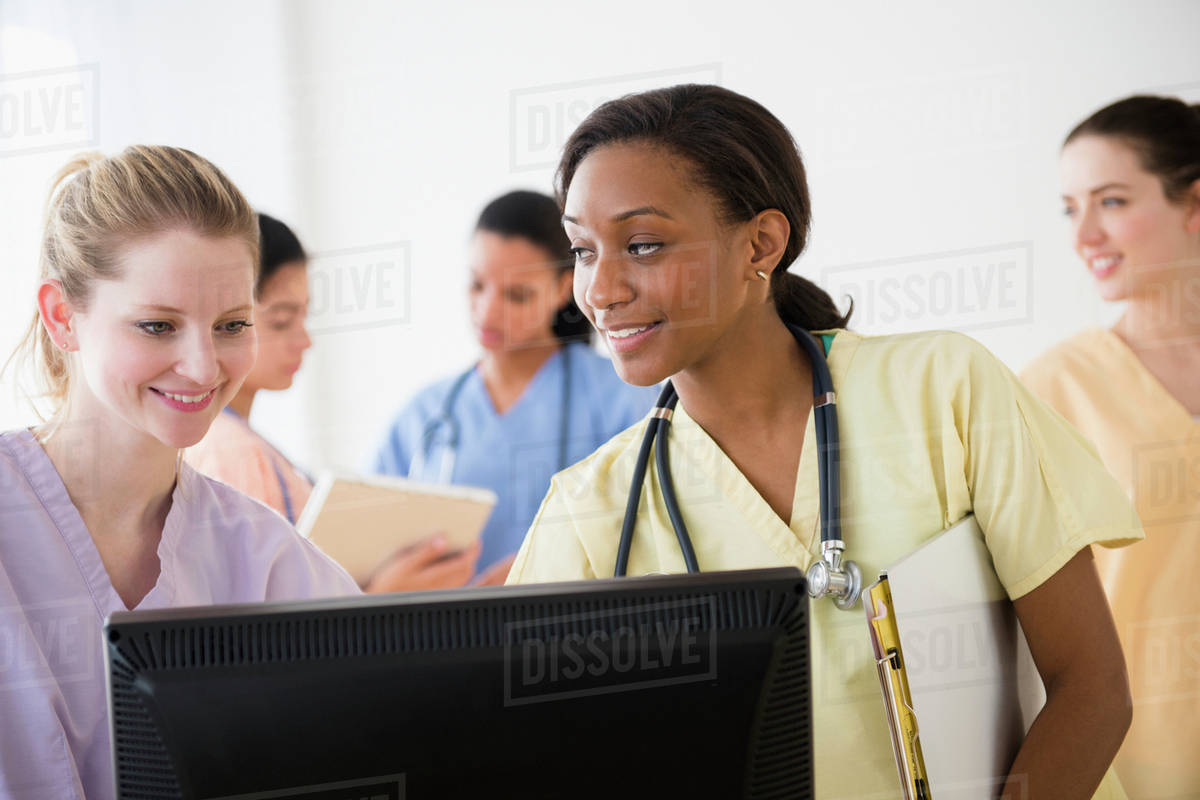 Nurses using computer together in hospital - Royalty-free Stock Photo ...