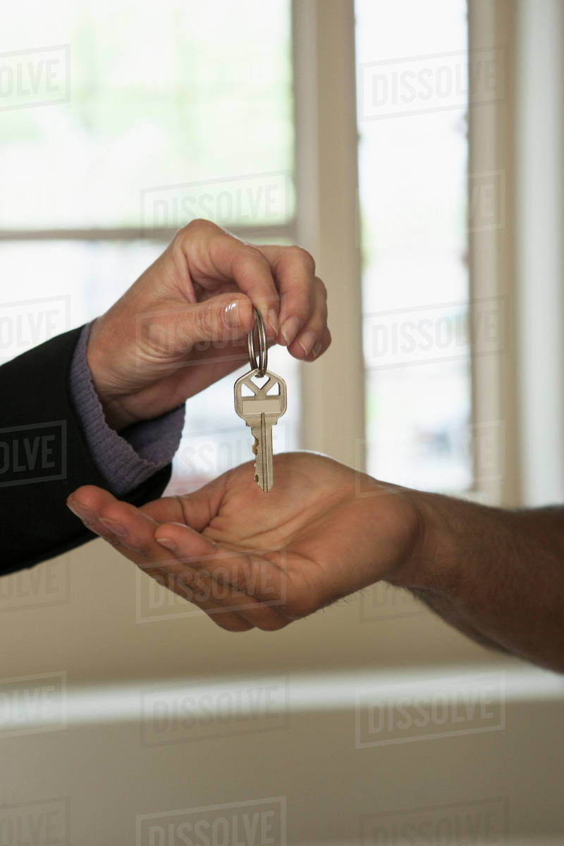 Realtor handing house keys to new owner - Royalty-free Stock Photo ...