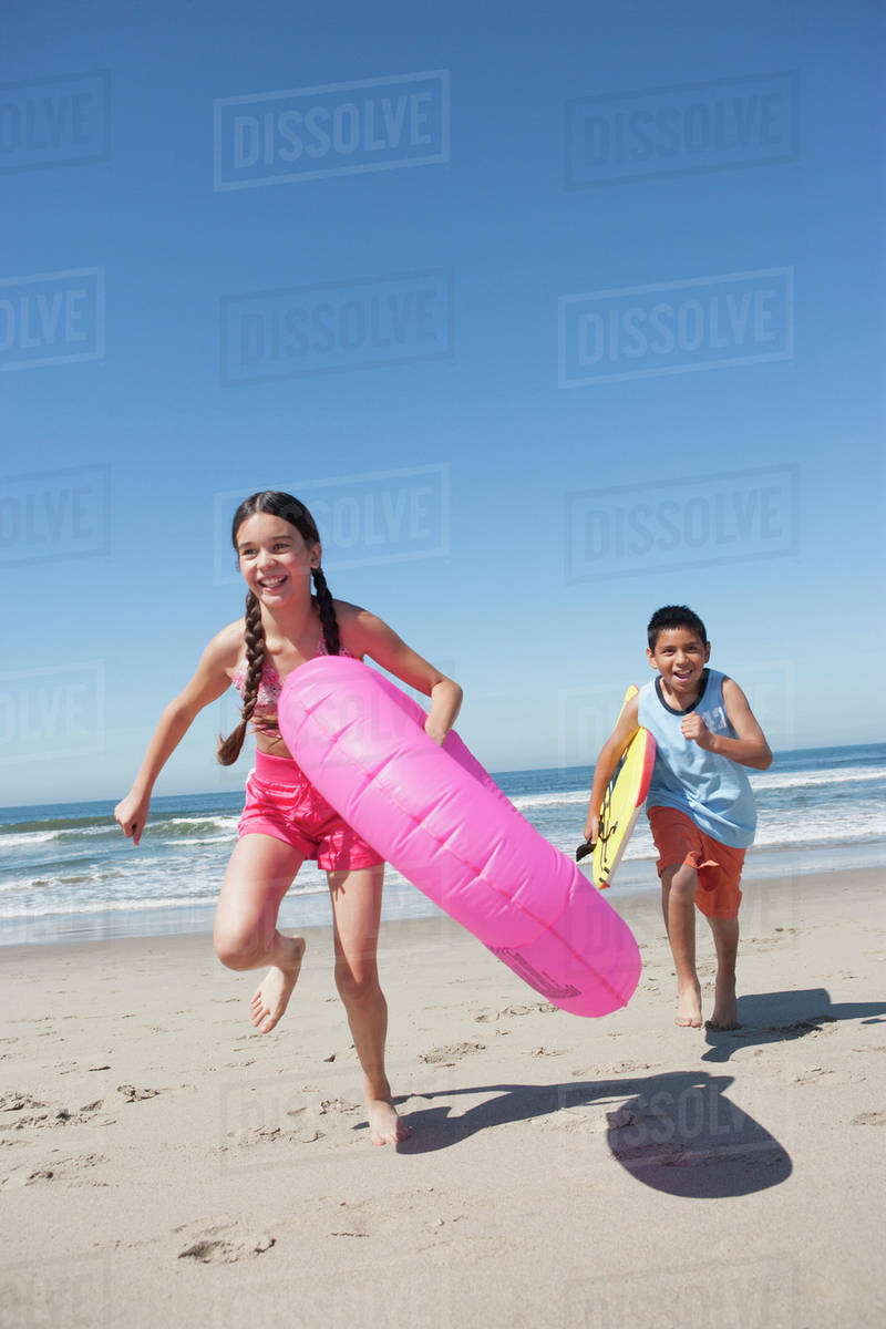 Hispanic children playing on beach - Royalty-free Stock Photo | Dissolve