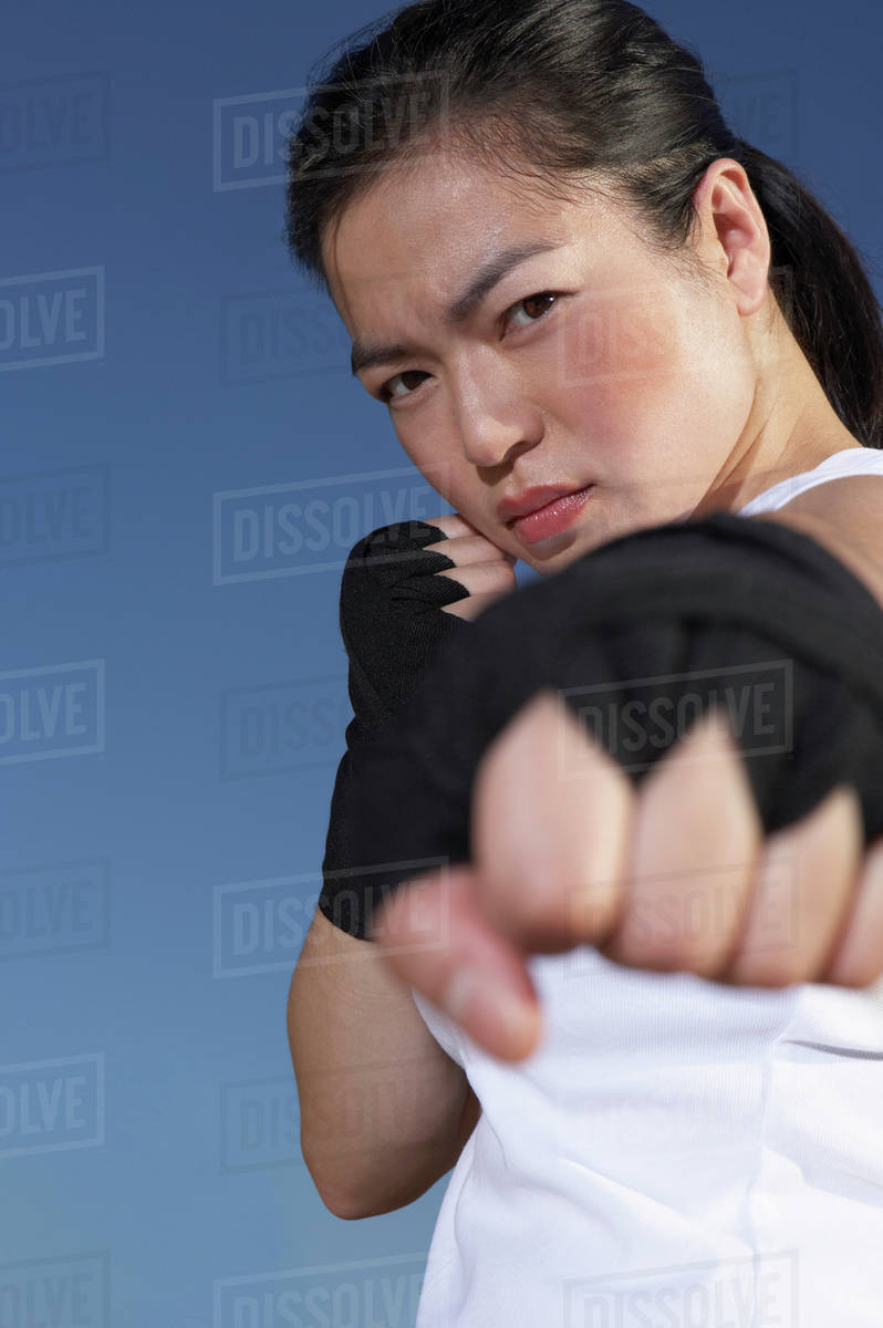 Chinese woman kick boxing outdoors - Royalty-free Stock Photo | Dissolve