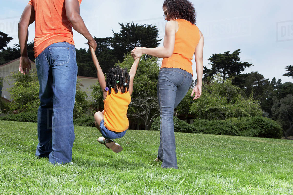 Family playing together in park - Royalty-free Stock Photo | Dissolve