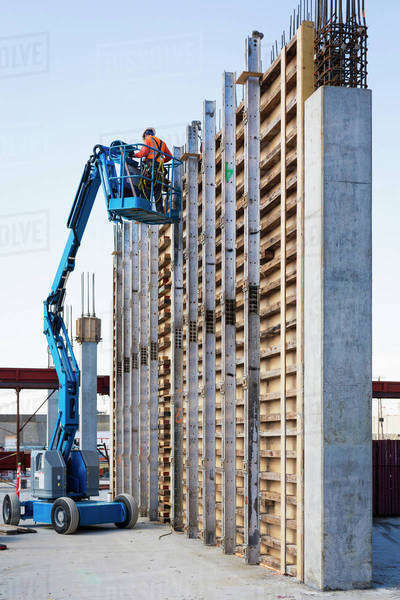 Caucasian worker on boom lift at construction site - Royalty-free Stock ...